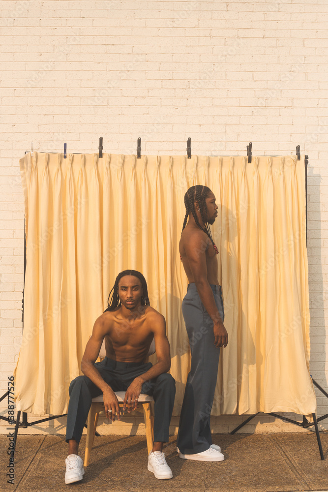 Two Guys Sitting And Standing Stock Photo | Adobe Stock