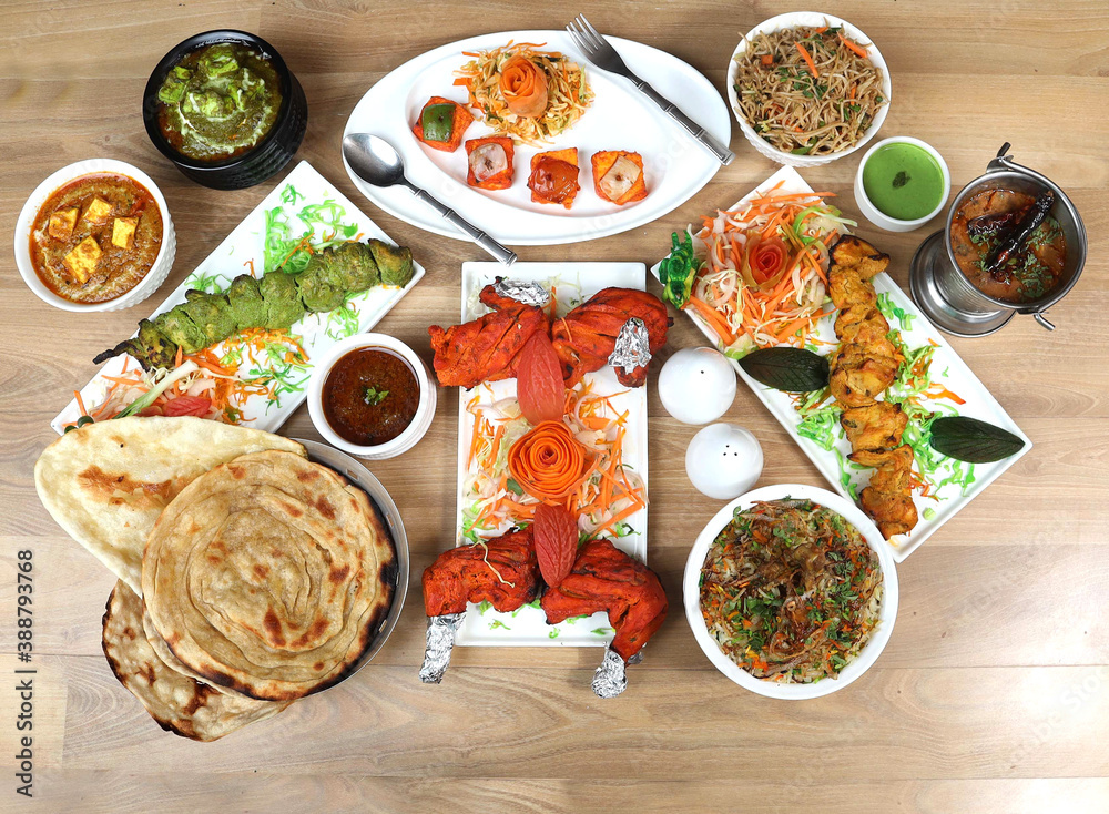 Assorted indian food on wooden background. Tandoori chicken,paneer ...