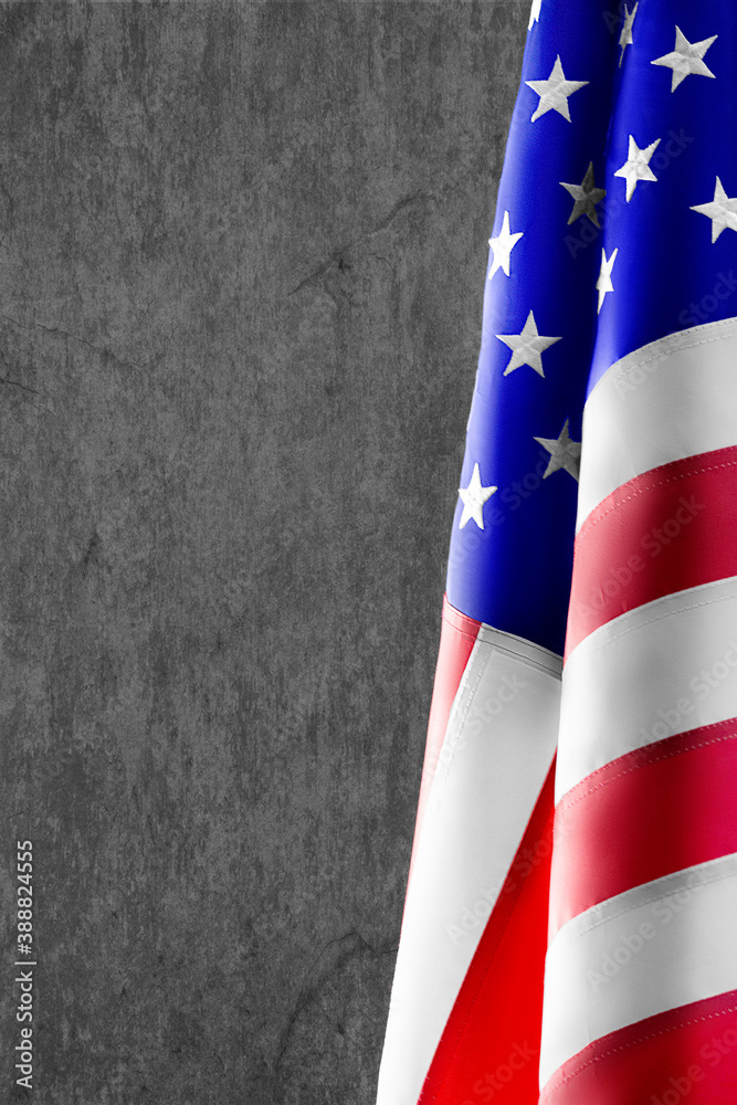Vertical photo of a US flag on concrete background. Background for ...