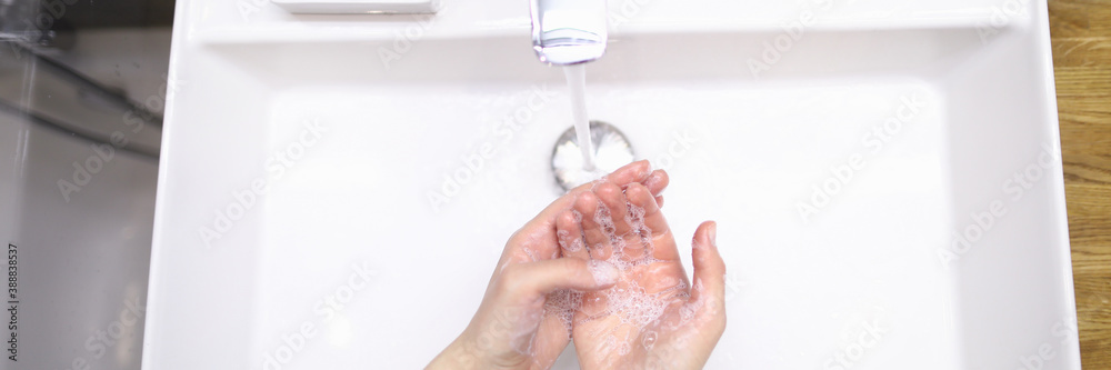 Top view of person washing hands with soap under water. Prevention ...