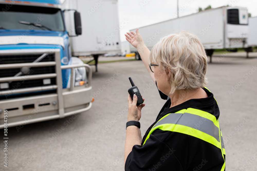 Warehouse owner directing container truck with radio transceiver Stock ...