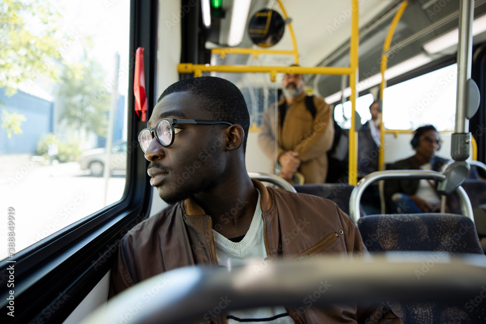 Young male passenger looking out public bus window Stock Photo | Adobe ...
