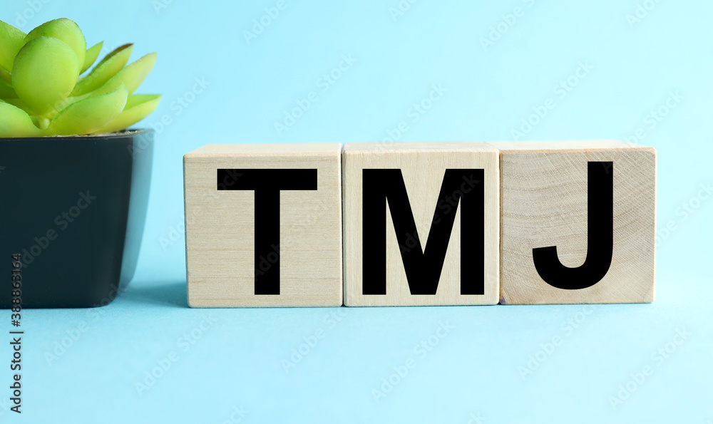 TMJ - acronym from wooden blocks with letters, abbreviation TMJ ...