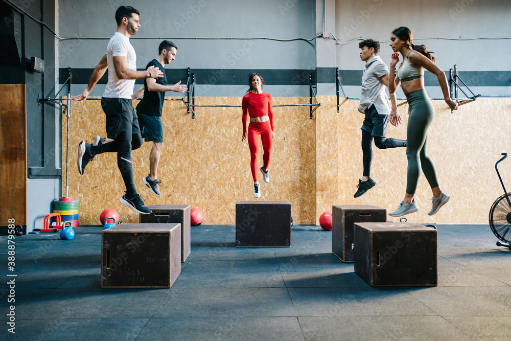 Group of athletes jumping on cubes during training Stock Photo | Adobe ...