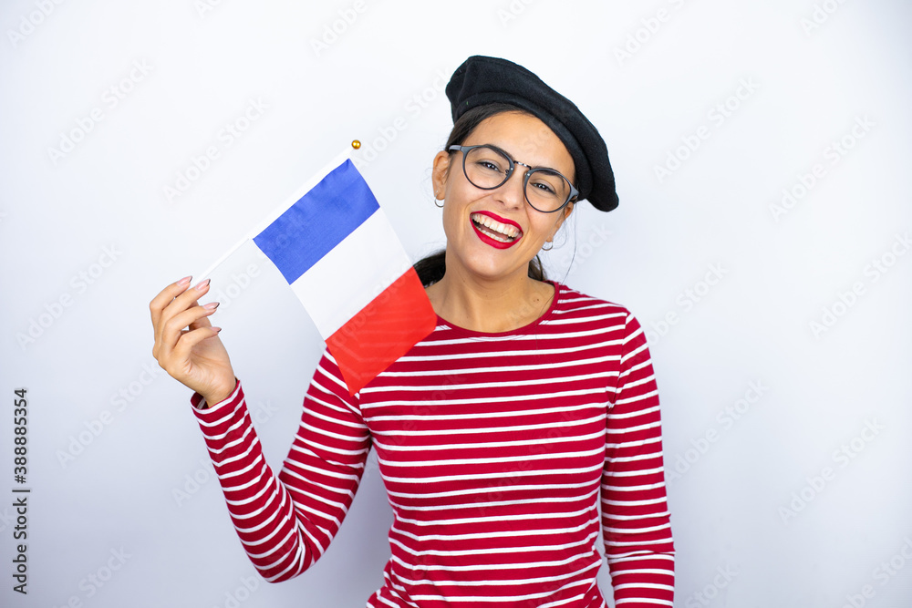 Young beautiful brunette woman wearing french beret and glasses over ...