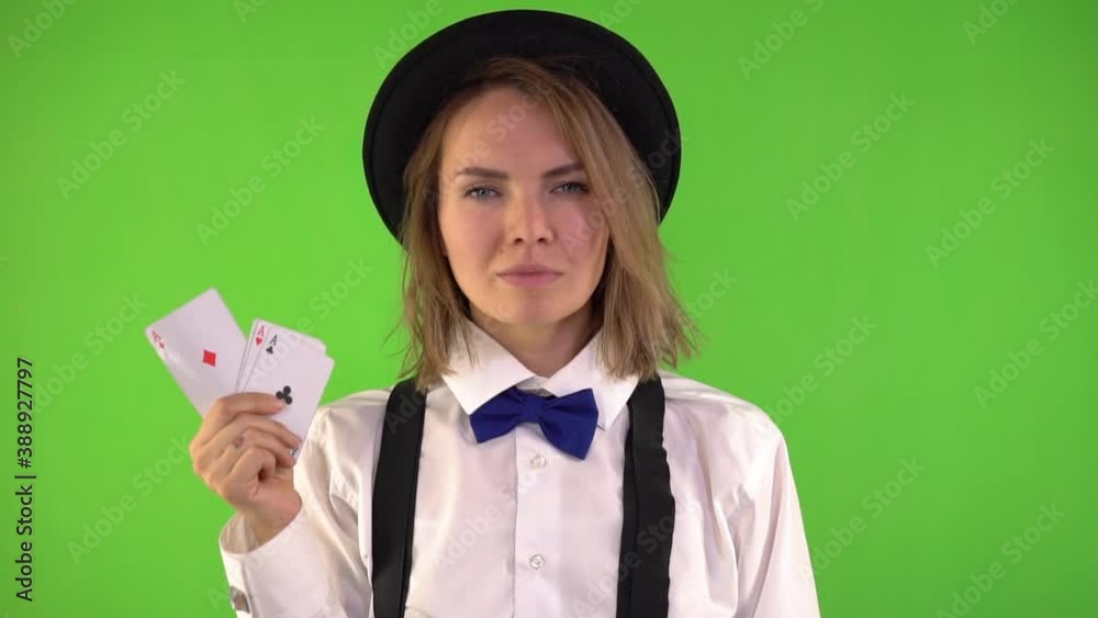 A Woman Dealer in a White Shirt and Hat Tries to Reveal Four Ace Cards ...
