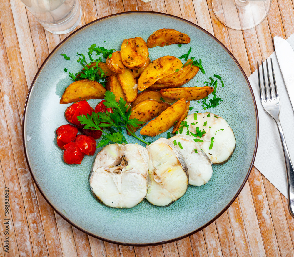 Hake fish dish, parsley, pickled tomatoes and potatoes Stock Photo ...