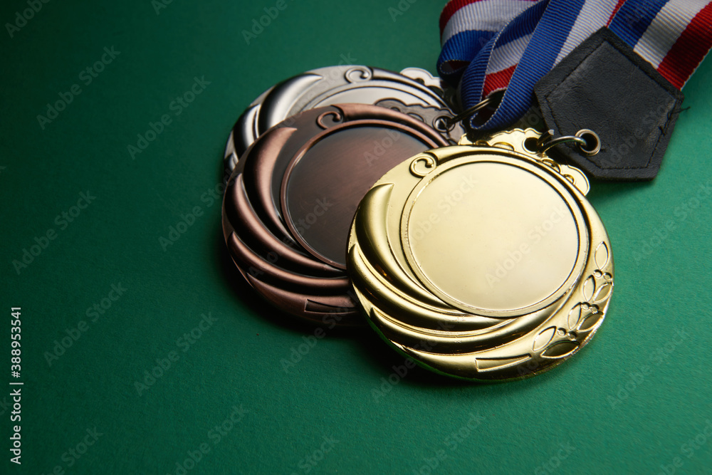 Gold, silver and bronze medal with ribbons. Award for first, second and ...