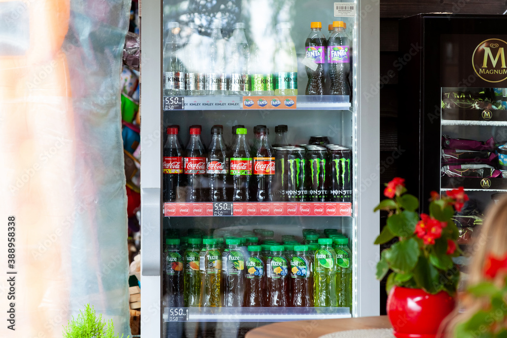 Various brands of beverages, rows of cold drinks in a fridge sold in a ...