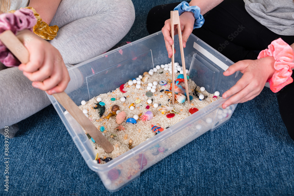Pediatric Sensory integration therapy - two kids picking up small ...