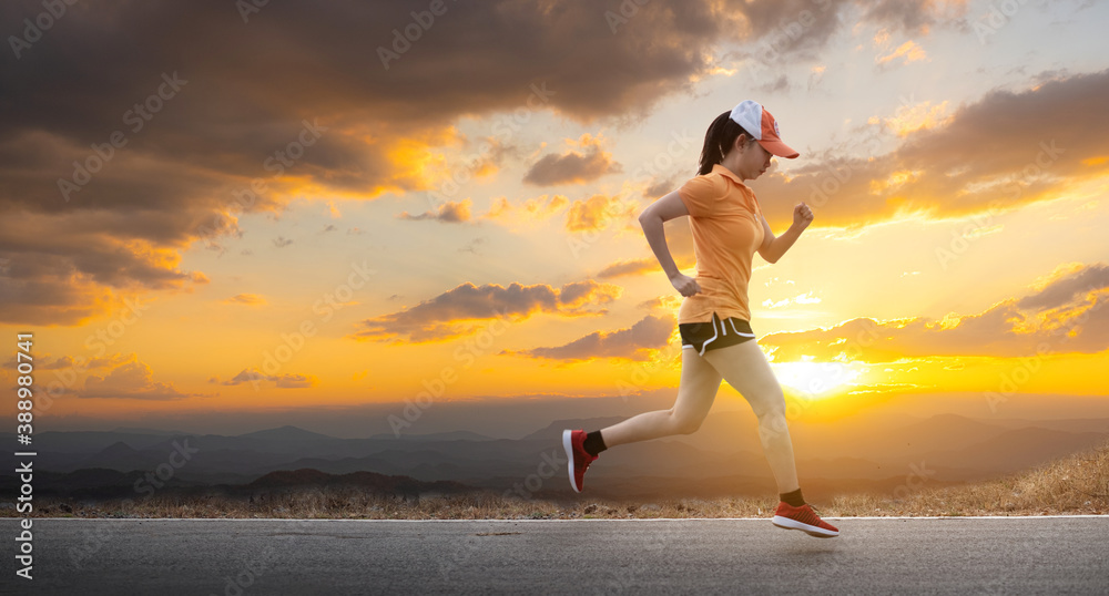 Photo side view Asia young woman runner running on asphalt road at the ...