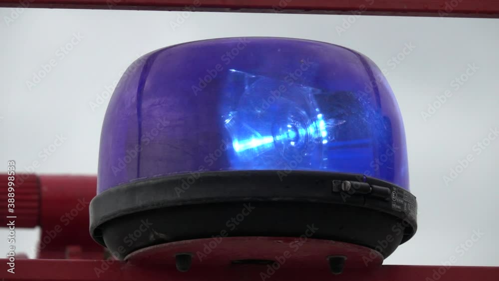 Blue flashing warning light, emergency services. Close up flash on fire ...
