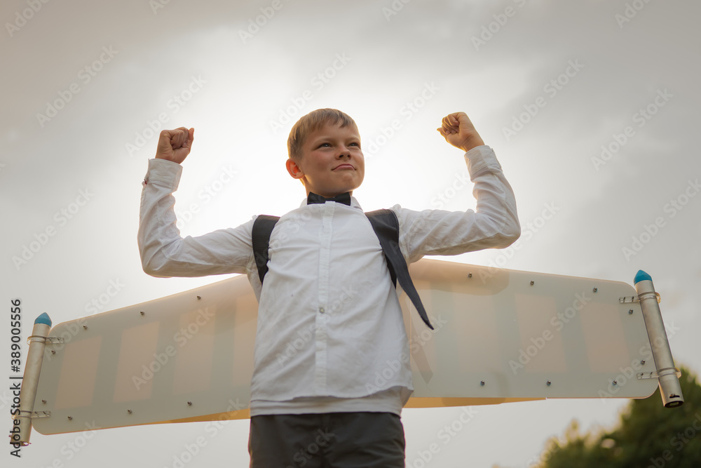 Boy wearing jetpack wings and playing outdoor. Pretending to fly Stock ...