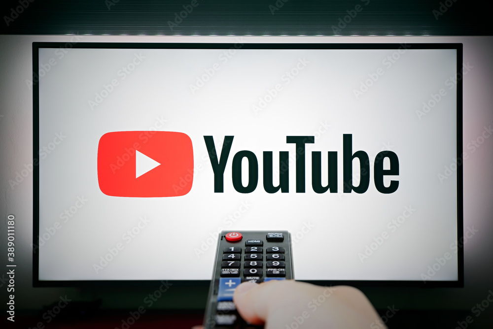 YouTube logo on TV screen. Remote control in hand Stock Photo | Adobe Stock
