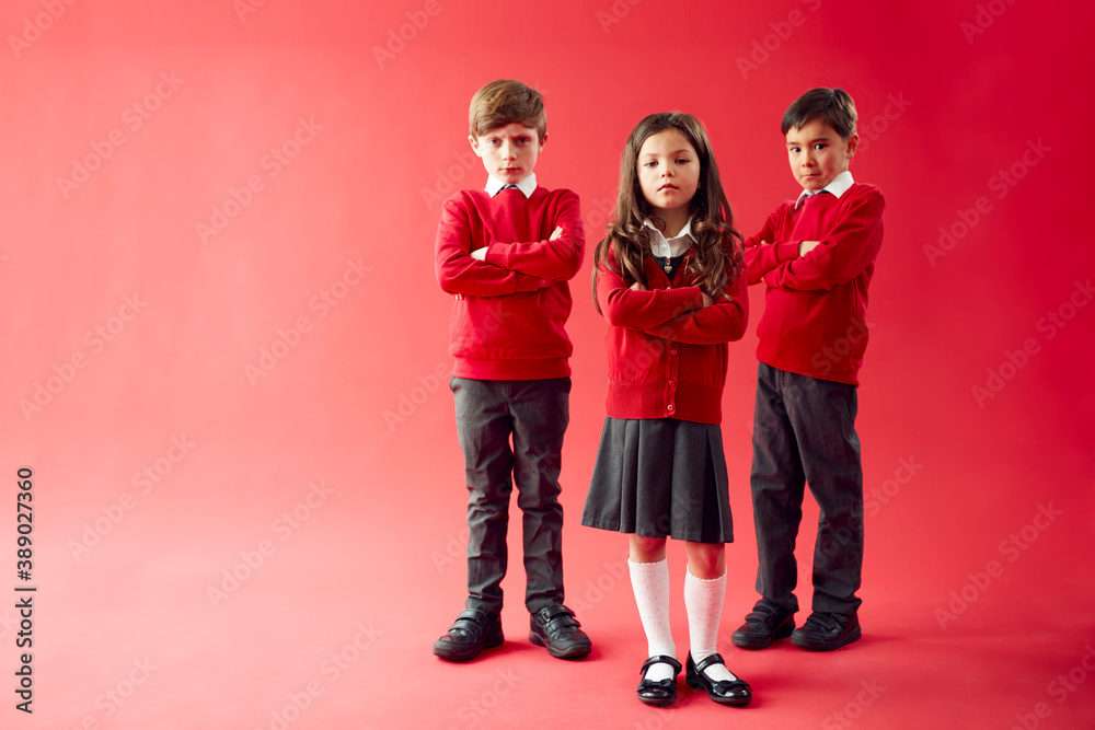 Group Of Elementary School Pupils Wearing Uniform Folding Arms Against ...