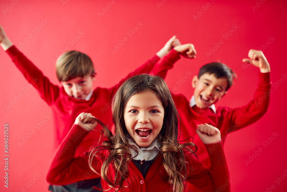 Portrait Of Excited Elementary School Pupils Wearing Uniform Having Fun ...