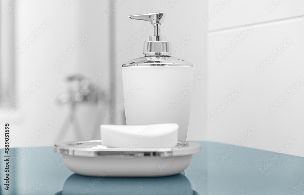 Liquid and ordinary soap in the bathroom. Cleanliness of hands and body ...