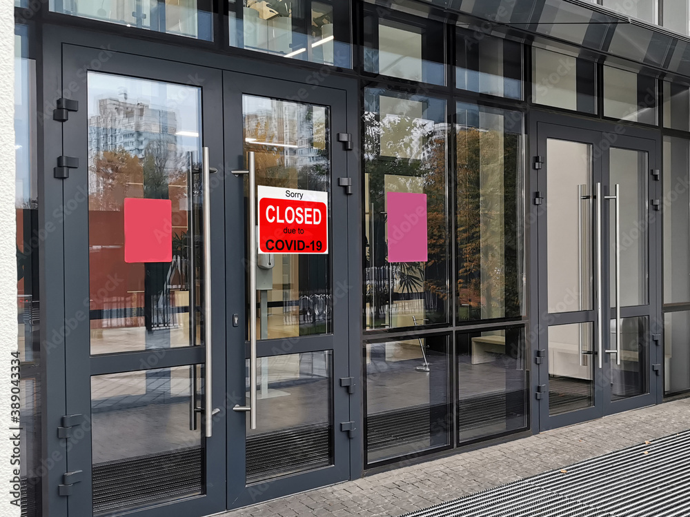 Business center closed due to COVID-19, sign with sorry in door window ...