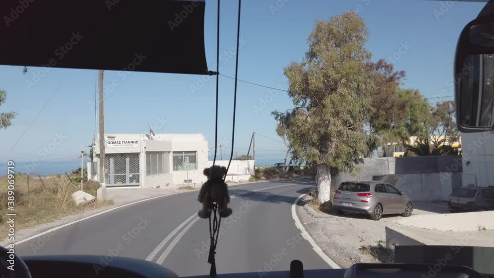 The bus driver is driving along the roads in Santorini, Greece Stock ...