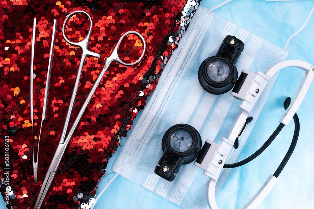 surgical instruments on a red shiny background. concept of holidays in ...