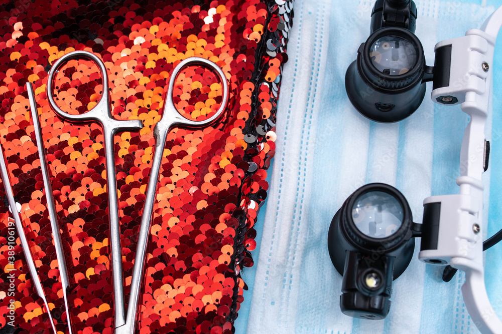 surgical instruments on a red shiny background. concept of holidays in ...