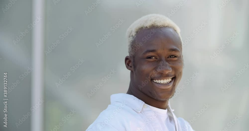 Attractive african american male student model stands posing on street ...