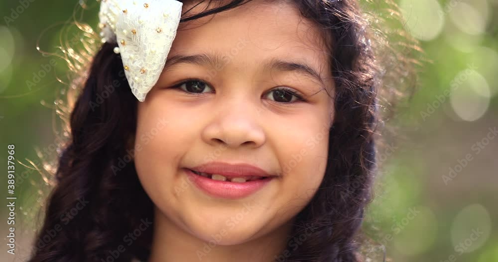 Hispanic child girl smiling portrait face close-up adjusting hair Stock ...