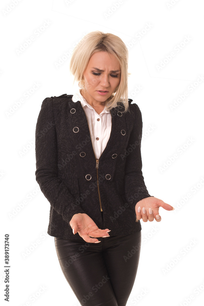 A young girl lowered her hands down stands and is sad on a white ...