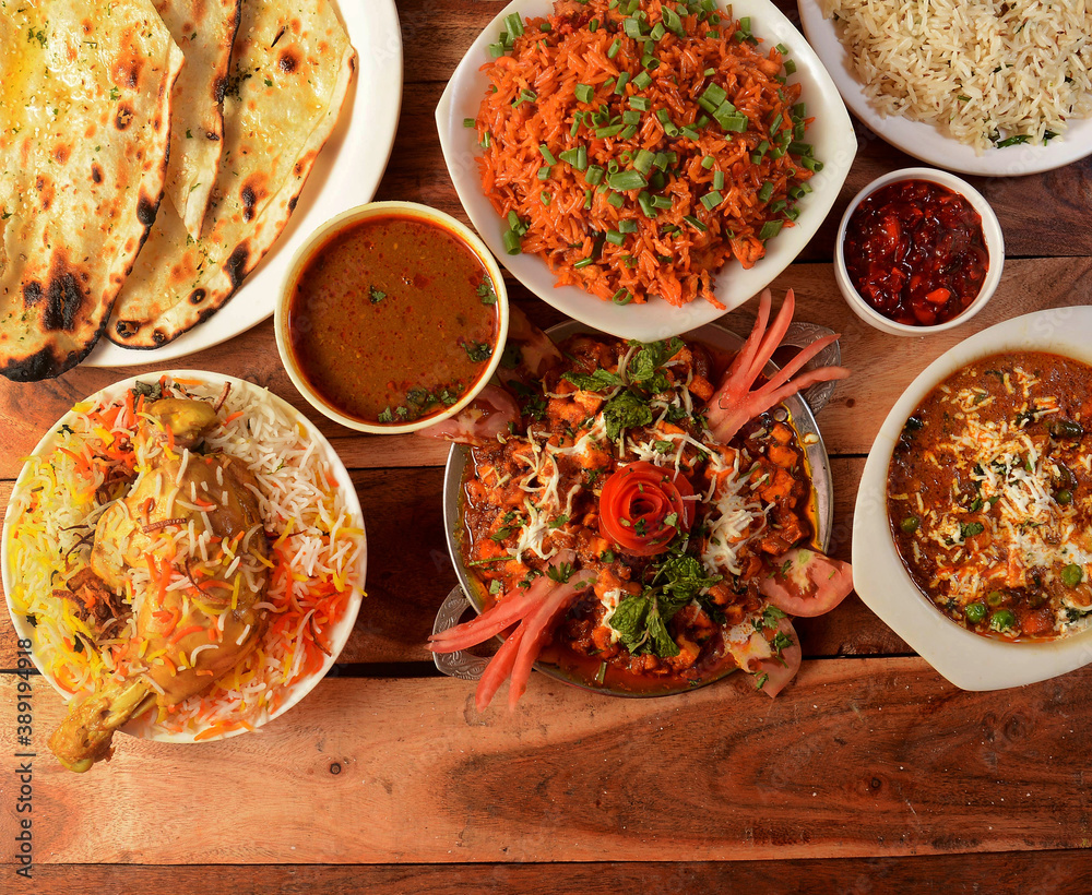 Assorted indian foods chicken biryani,butter naan,schezwan fried rice ...