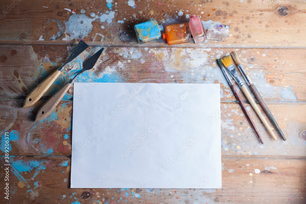 Artist desk and materials mockup.Various brushes,pallete knives and ...