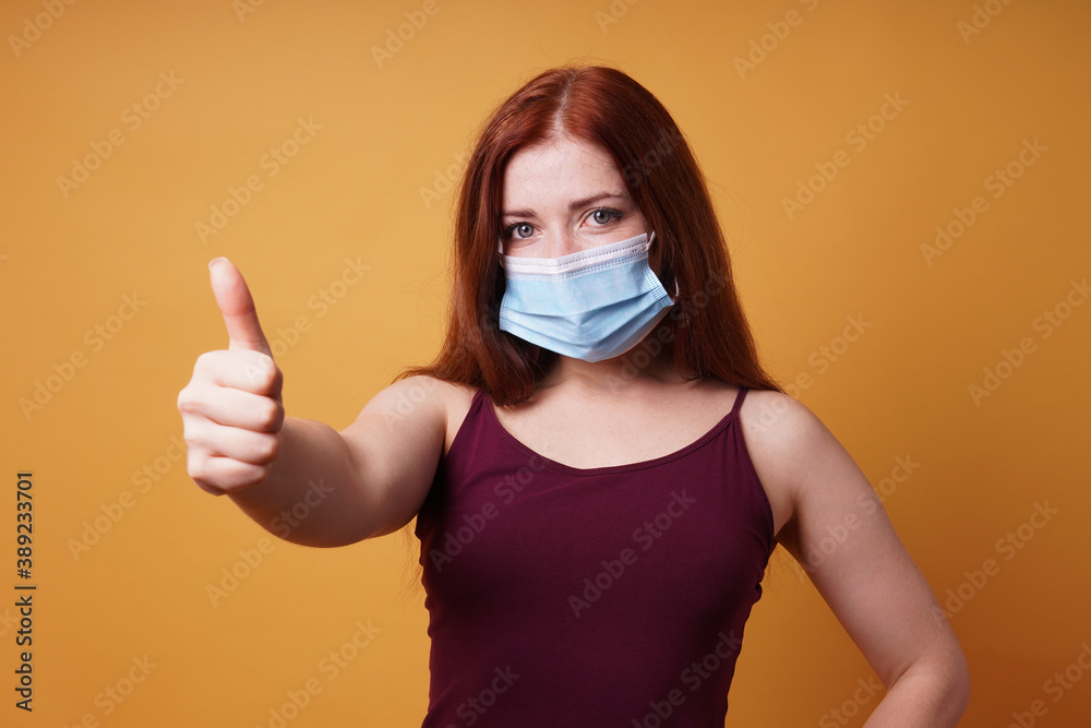 young woman wearing a medical face mask correctly covering mouth and ...