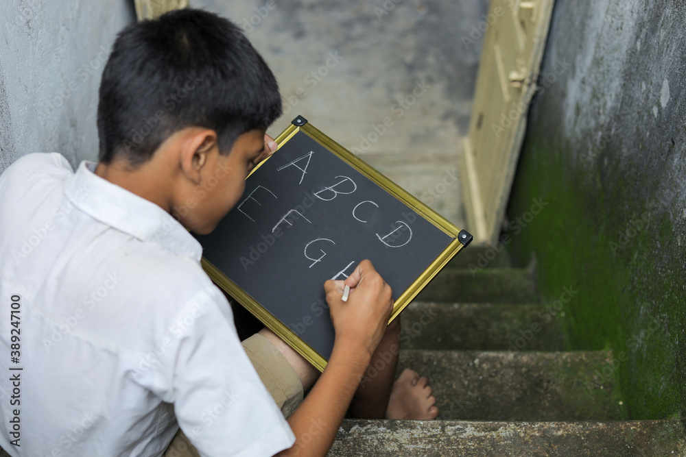 Indian child writing A B C D alphabet on Chalkboard Stock Photo | Adobe ...
