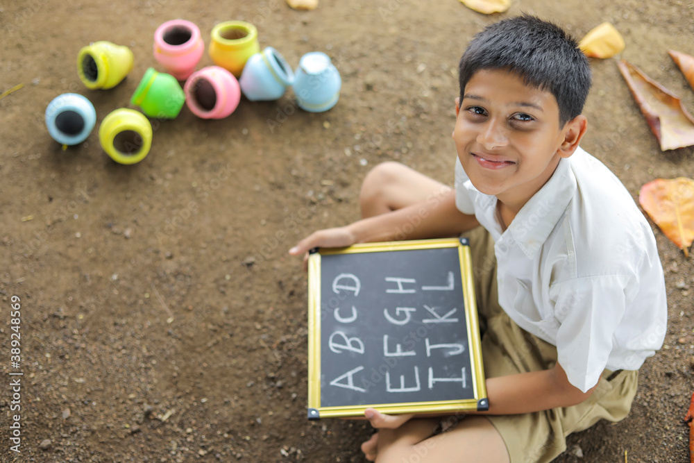 Indian child writing A B C D alphabet on Chalkboard Stock Photo | Adobe ...