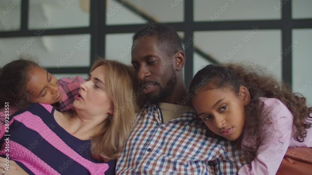 Portrait of positive multiracial family with two cute preadolescent ...