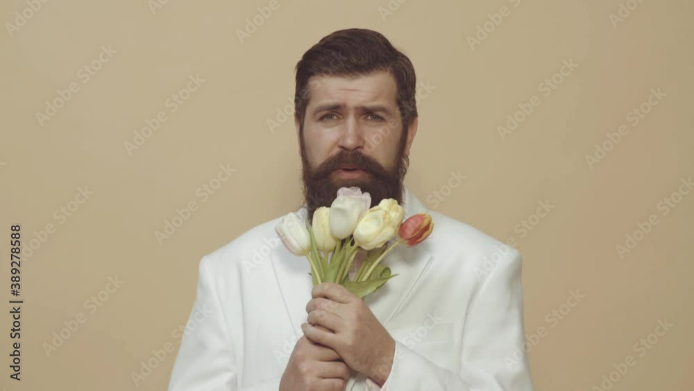 Funny emotions. Man with flowers. Young headsome attractive enamored ...