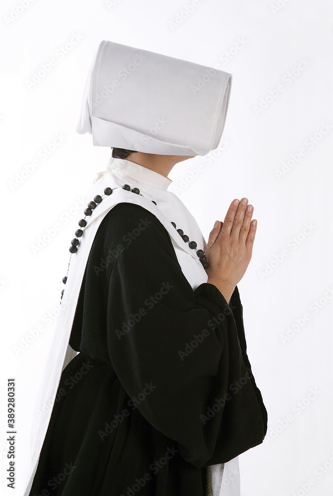 Nun standing and praying. White background. Stock Photo | Adobe Stock