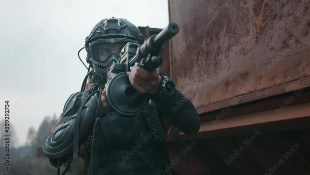 Female surviving future soldier aims with assault rifle and moves ...