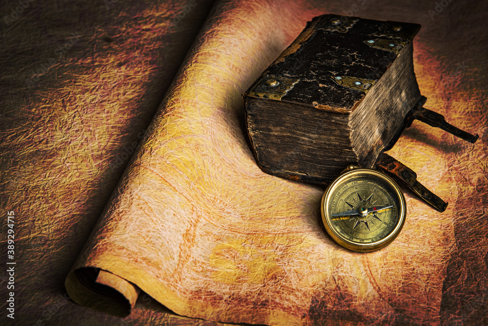 Ancient rotten book and compass on an old parchment Stock Photo | Adobe ...