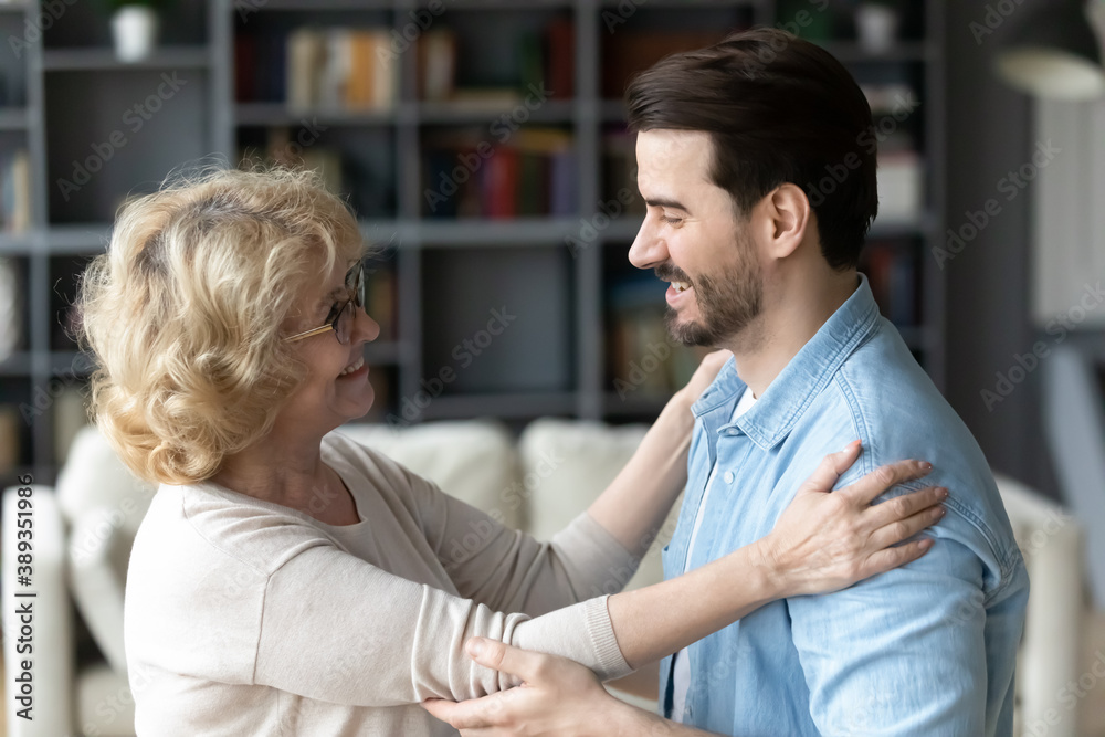 Side view happy elderly retired beautiful woman welcoming grown joyful ...