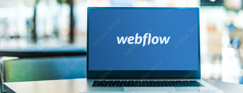 Laptop computer displaying logo of Webflow Stock Photo | Adobe Stock