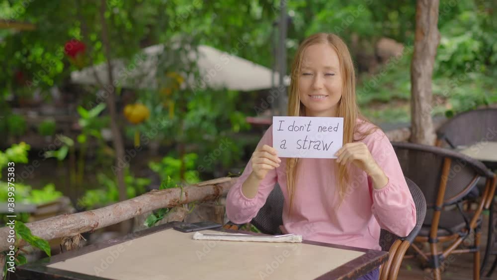 In a cafe, a young woman refuses to take a single-use plastic drinking ...