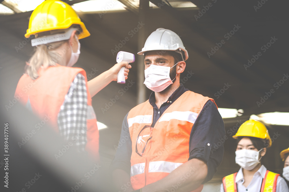 Temperature measurement with employee temperature meter before entering ...