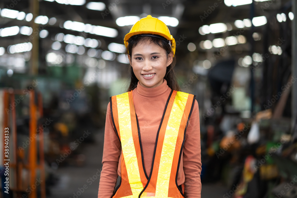 Woman worker wearing safety goggles at Metal lathe industrial ...