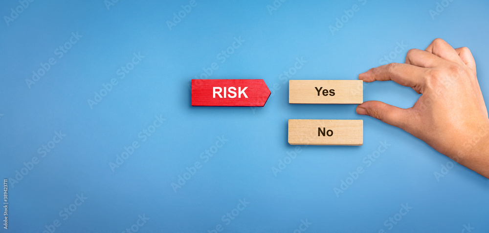 Risk concept with text Yes and No. Hand holding wooden block with text ...
