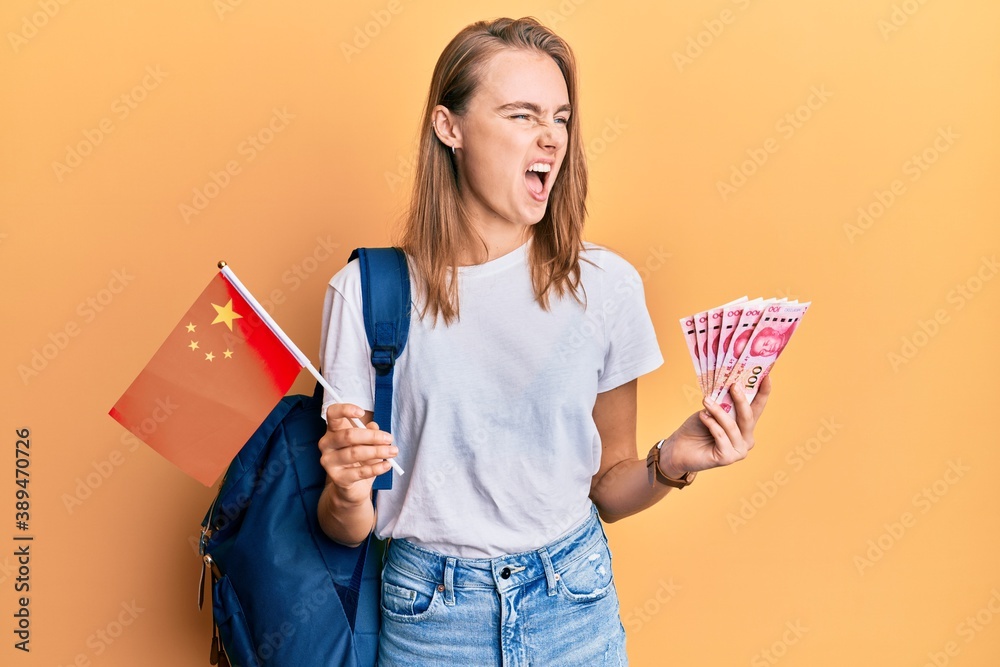 Beautiful blonde woman exchange student holding china flag and yuan ...