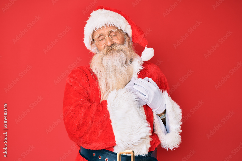 Old senior man with grey hair and long beard wearing traditional santa ...