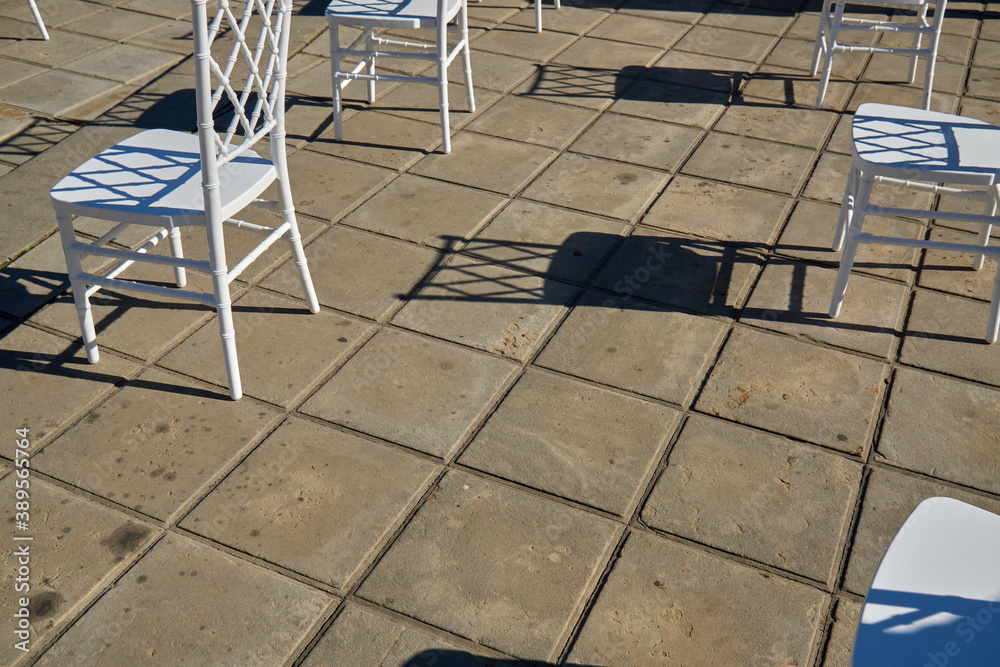 Large group of empty white chairs arranged for social distance, ready ...