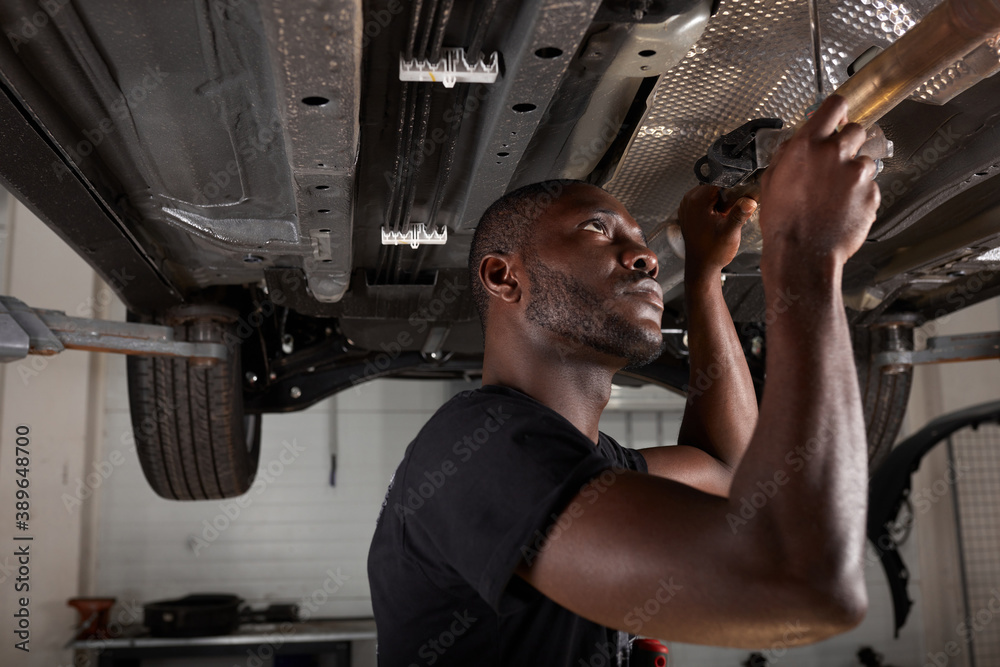 Male Mechanic Under Car