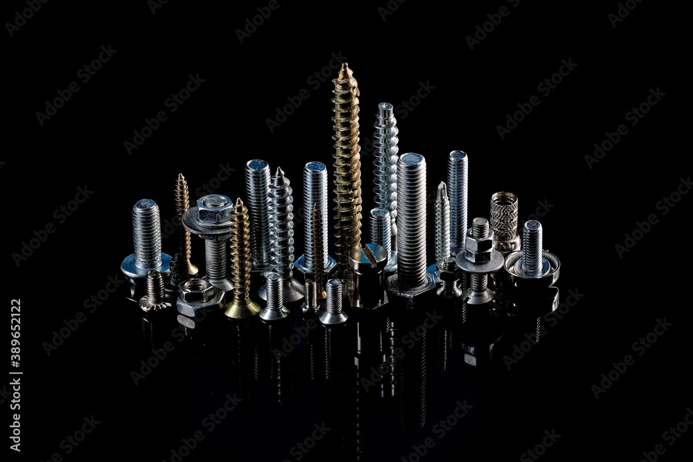 Night city of screws, bolts and nuts with reflection on a black ...