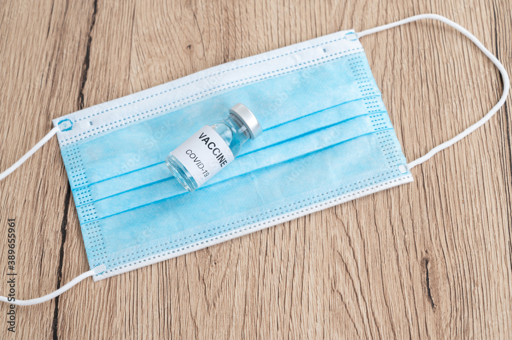 Coronavirus Covid-19 Vaccine vial and Face mask Put on the doctor's ...